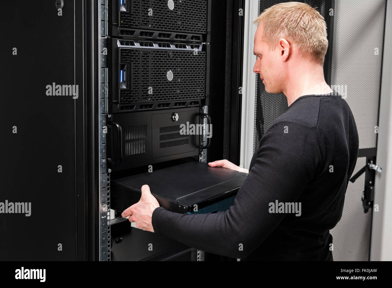 It consultant install network router in datacenter Stock Photo - Alamy