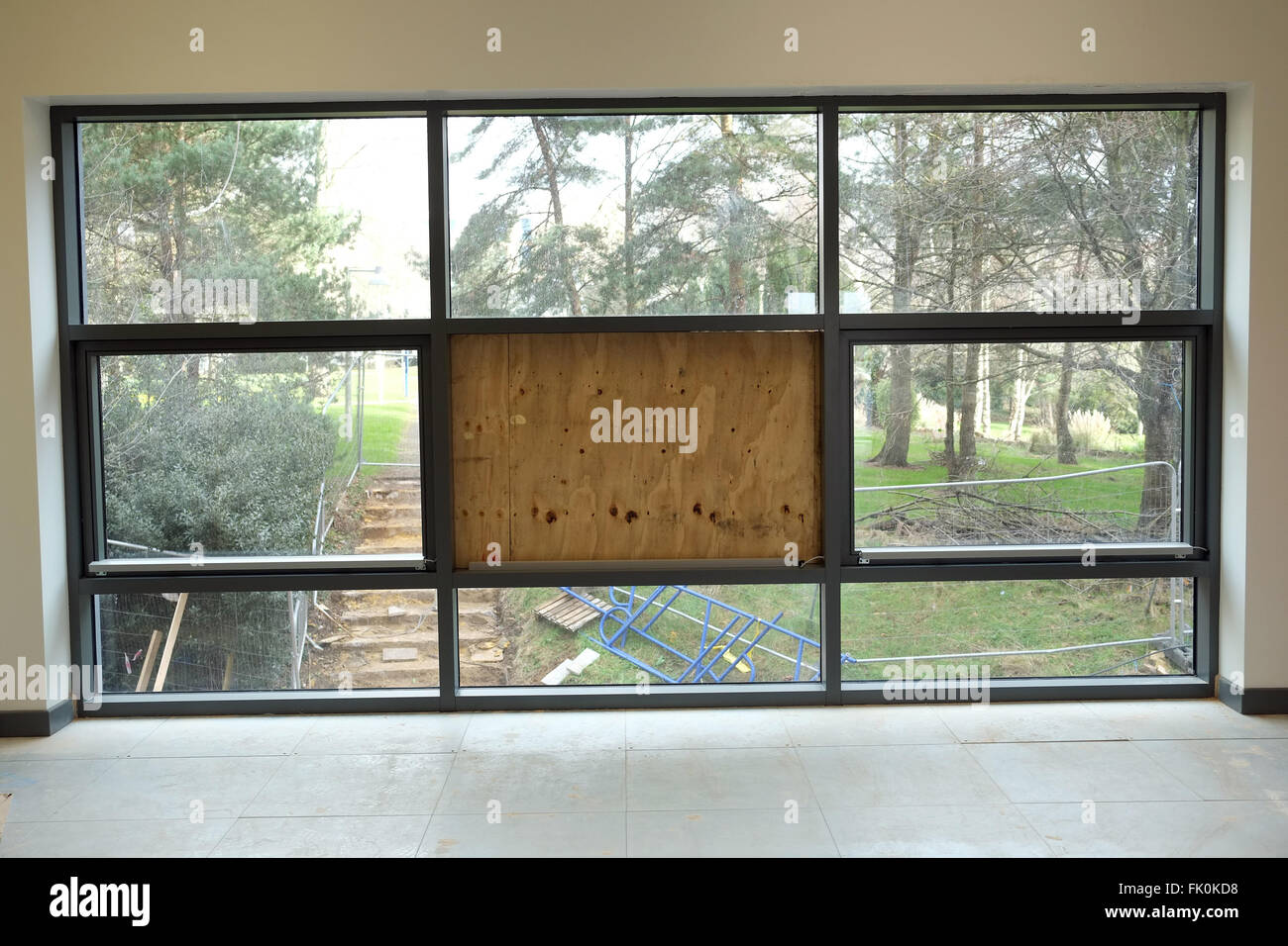Broken window with a piece of ply wood a a temporary measure. March ...