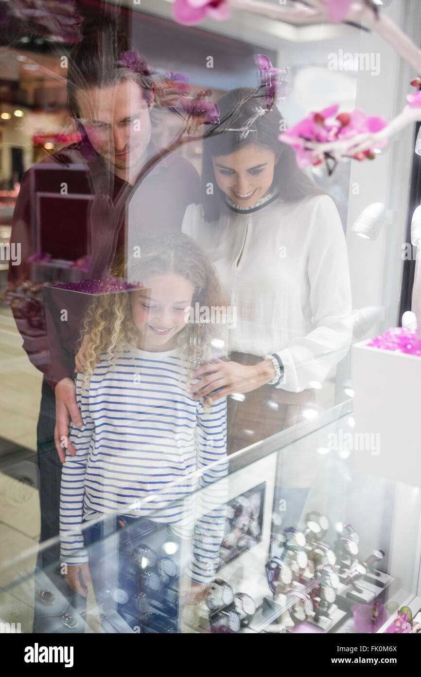 Happy family window shopping in mall Stock Photo - Alamy