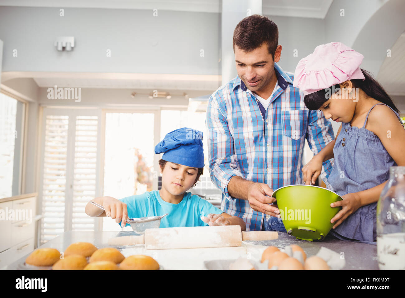 Children helping father in preparing food Stock Photo - Alamy