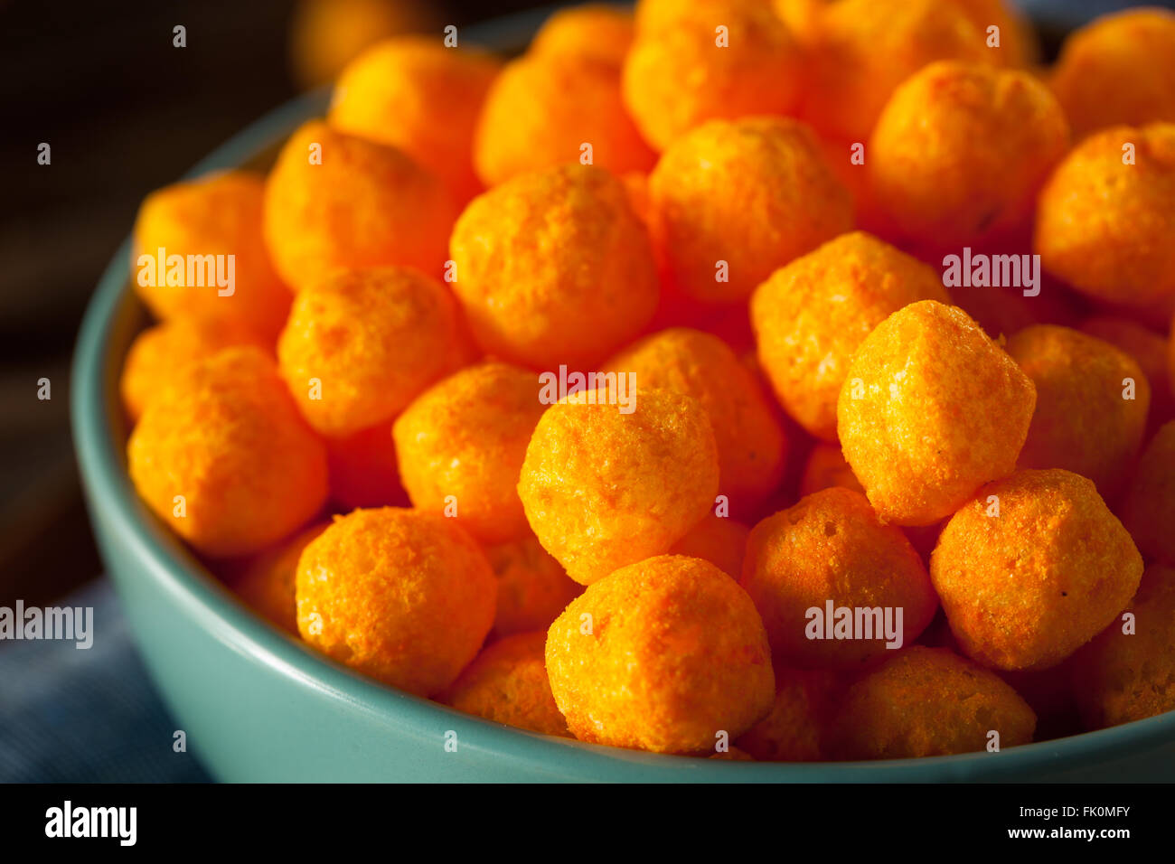 Unhealthy Cheesy Cheese Puffs in a Bowl Stock Photo - Alamy