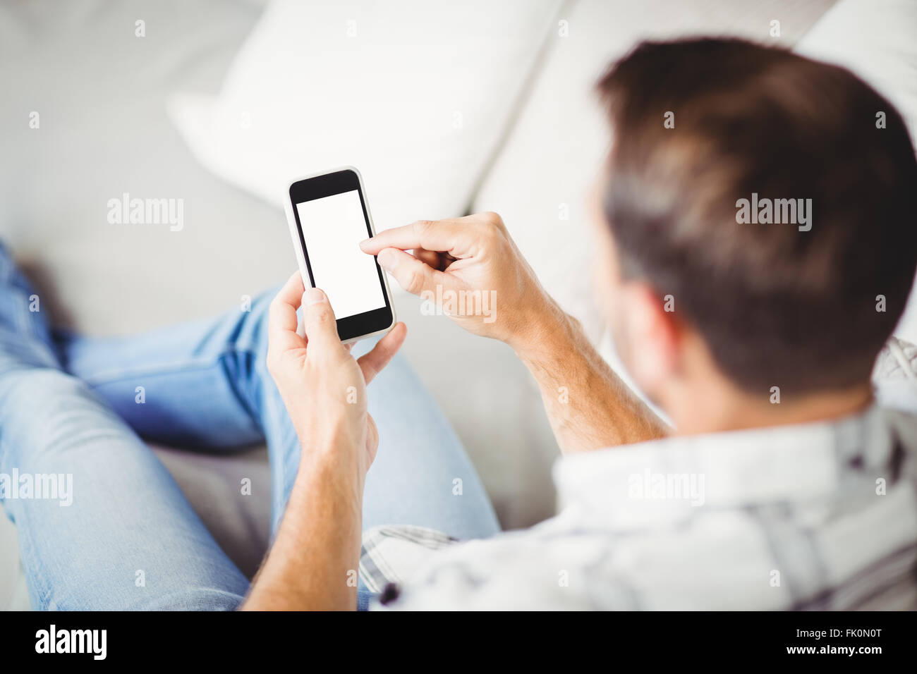 Rear view of man using mobile phone Stock Photo - Alamy