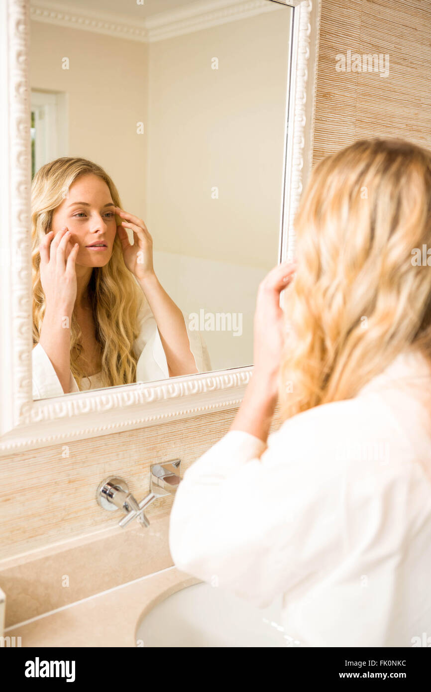 Pretty woman looking at herself in the mirror Stock Photo - Alamy
