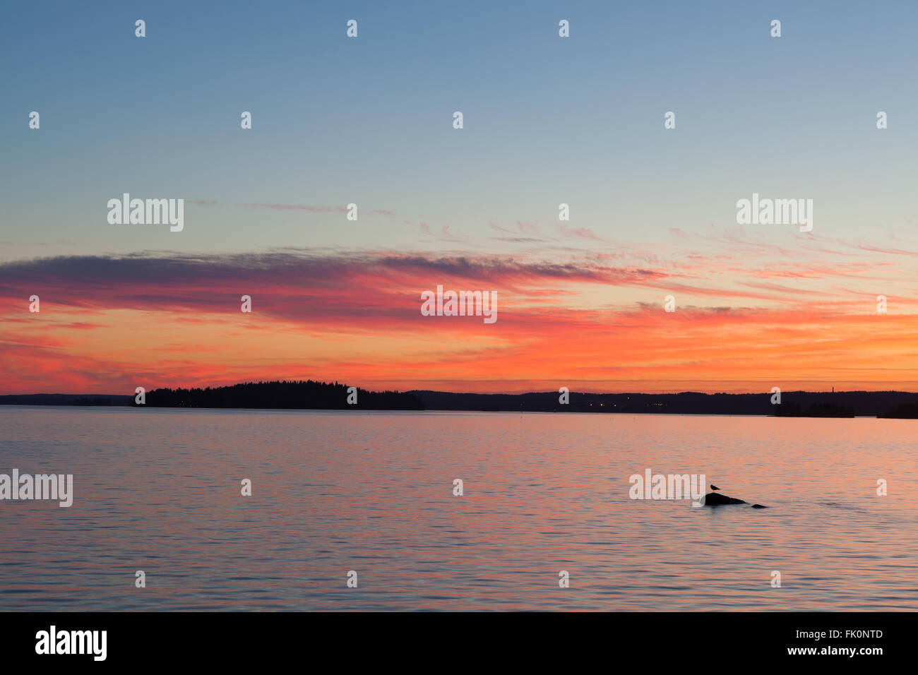 Calm sunset and clouds over lake Stock Photo - Alamy