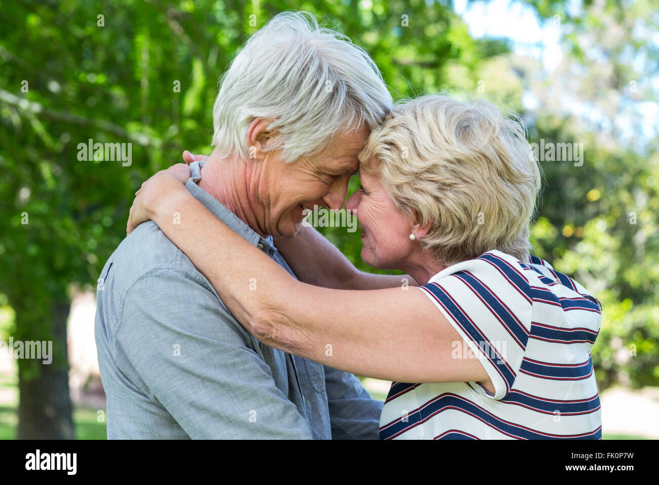 Senior couple embracing head to head Stock Photo - Alamy