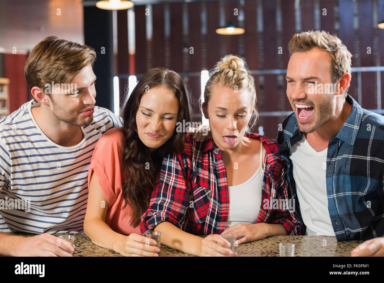 Friends making faces because of shots Stock Photo - Alamy