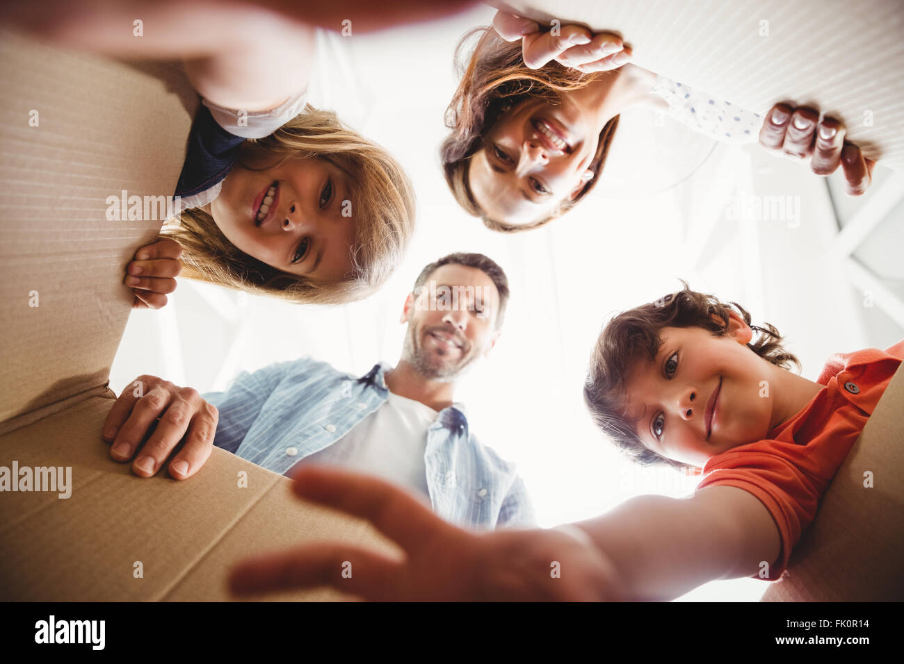 Smiling family with cardboard boxes Stock Photo - Alamy