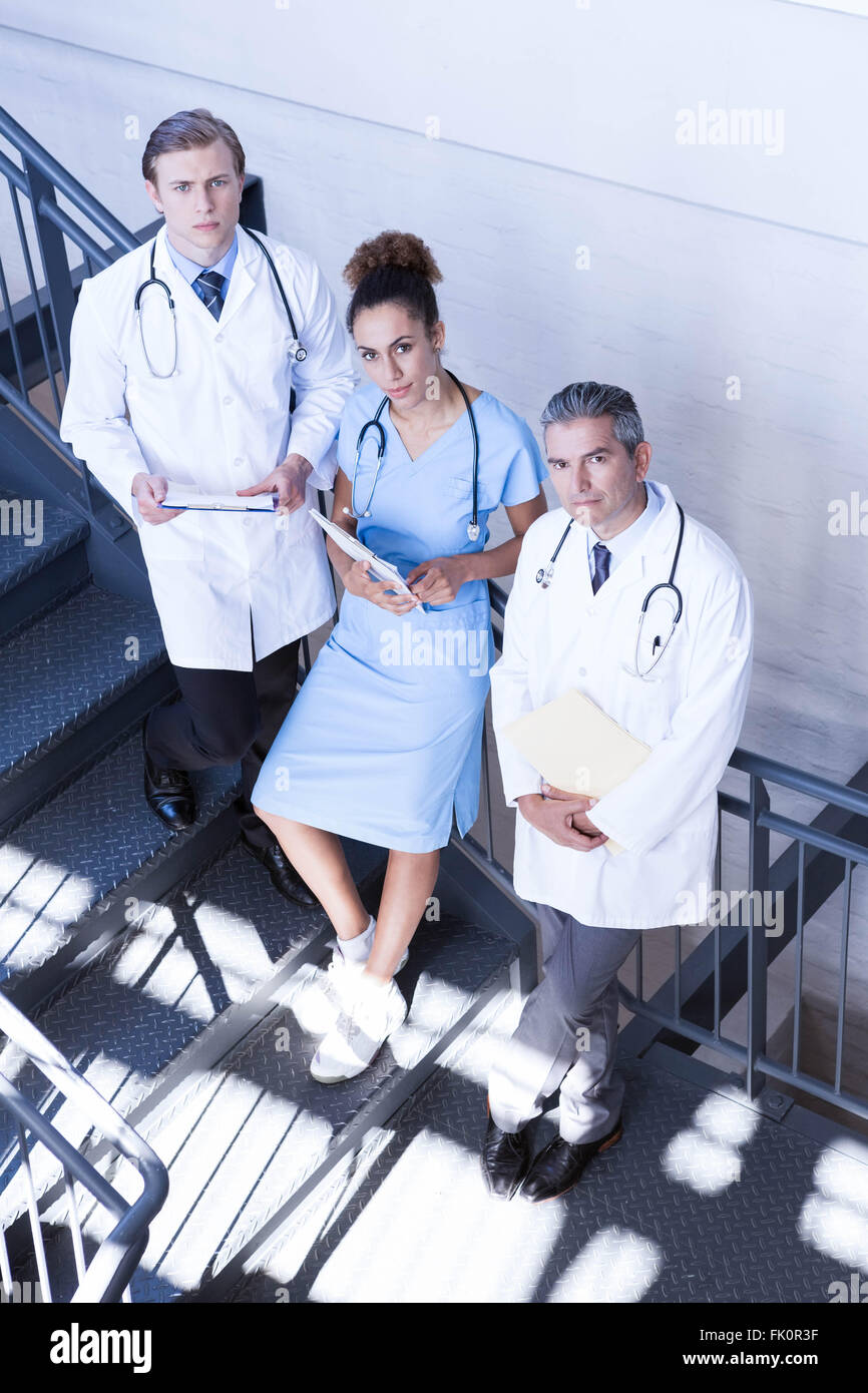 Portrait of doctors standing on staircase with document Stock Photo - Alamy