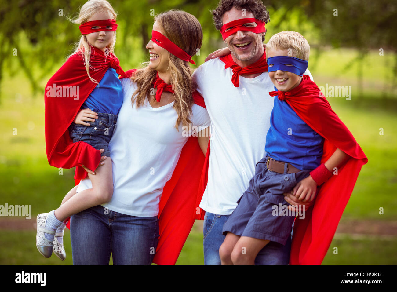 Happy family pretending to be superhero Stock Photo - Alamy