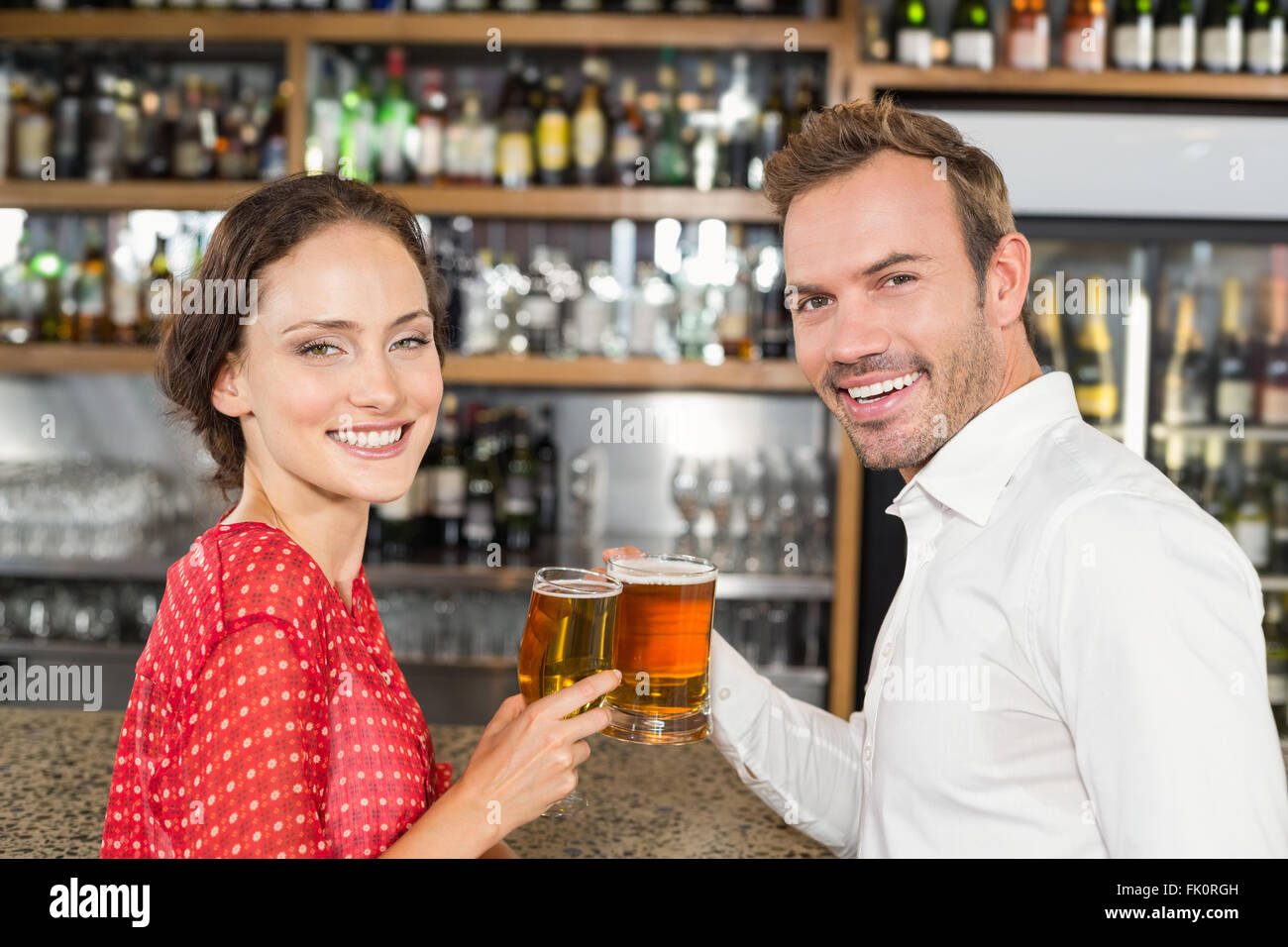 Couple smiling at camera Stock Photo - Alamy