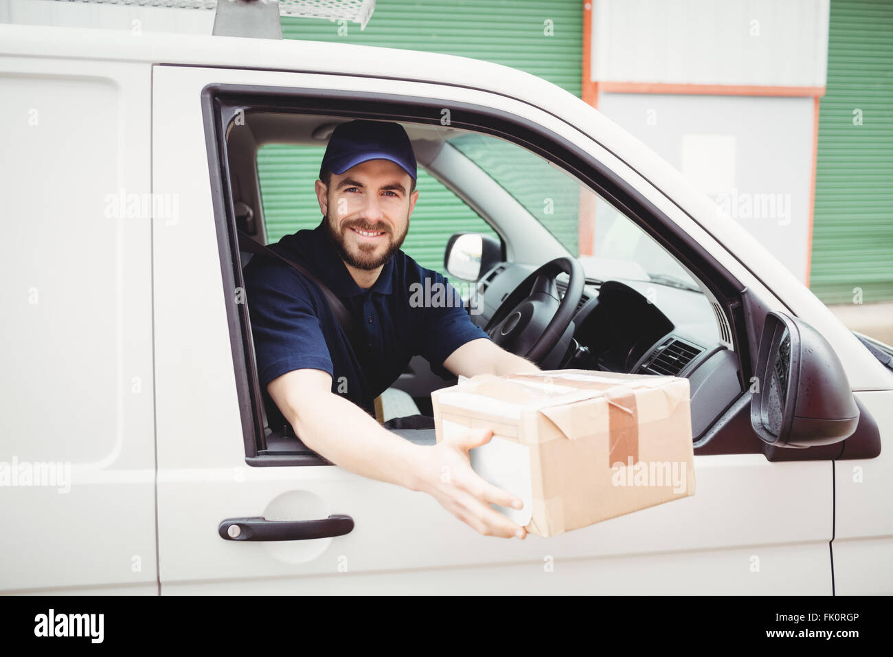 Delivery man sitting in his van Stock Photo - Alamy