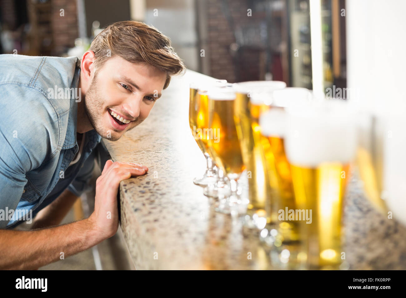 Man looking down lined up beers Stock Photo - Alamy