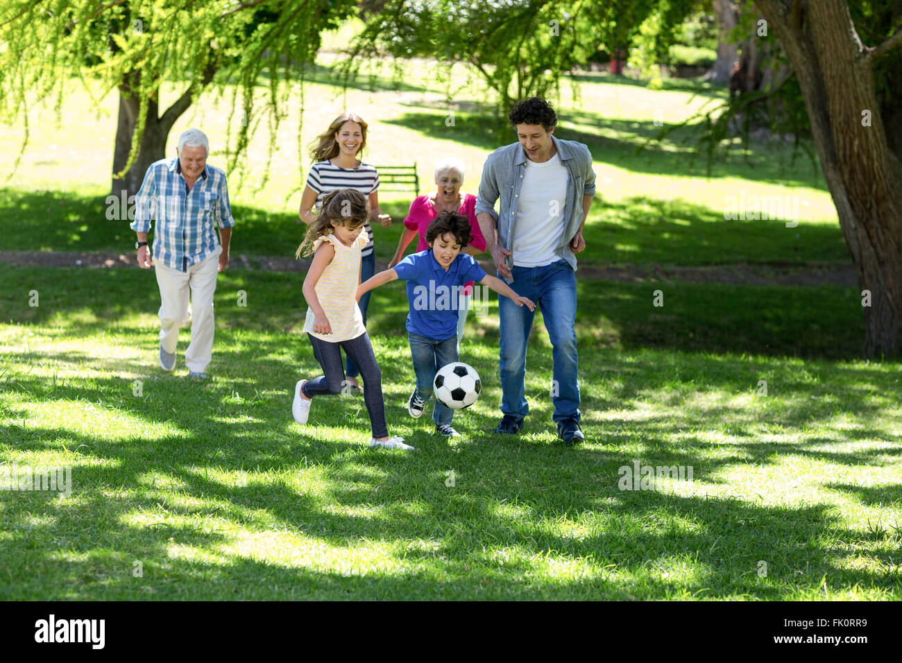Smiling family playing football Stock Photo - Alamy