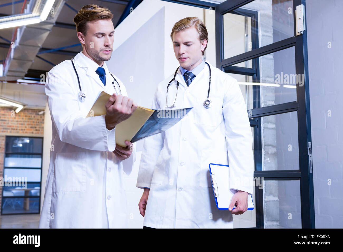 Doctors discussing a medical report Stock Photo - Alamy
