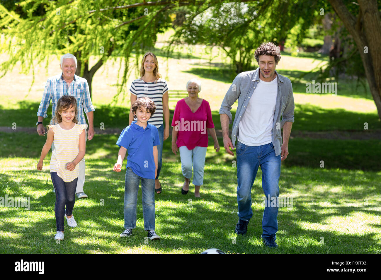 Smiling family walking Stock Photo - Alamy