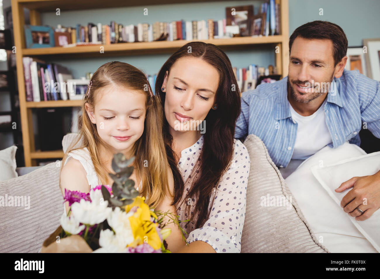 Smiling family with flower bouquet Stock Photo - Alamy