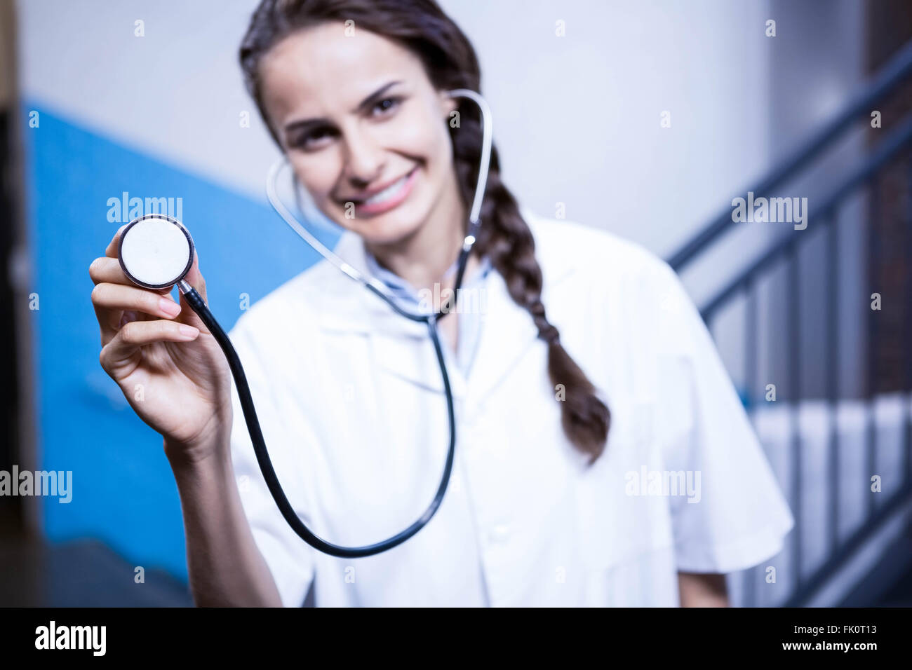 Portrait of female doctor showing stethoscope Stock Photo - Alamy