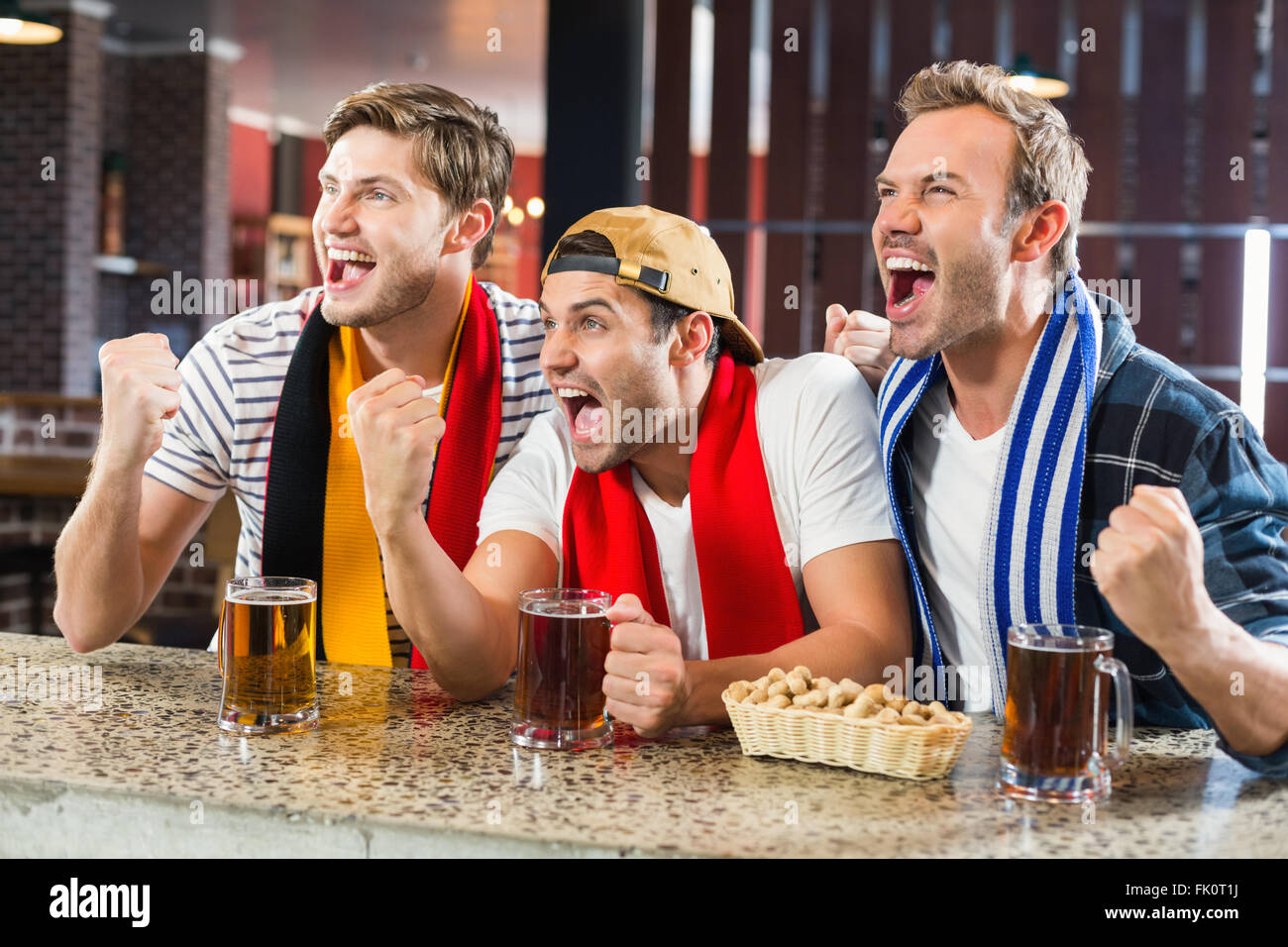 Men pint pub cheering hi-res stock photography and images - Alamy