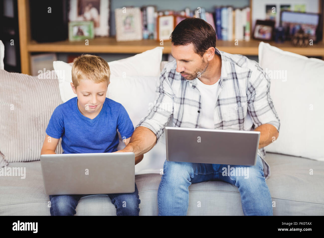 Man and son working on laptop Stock Photo - Alamy