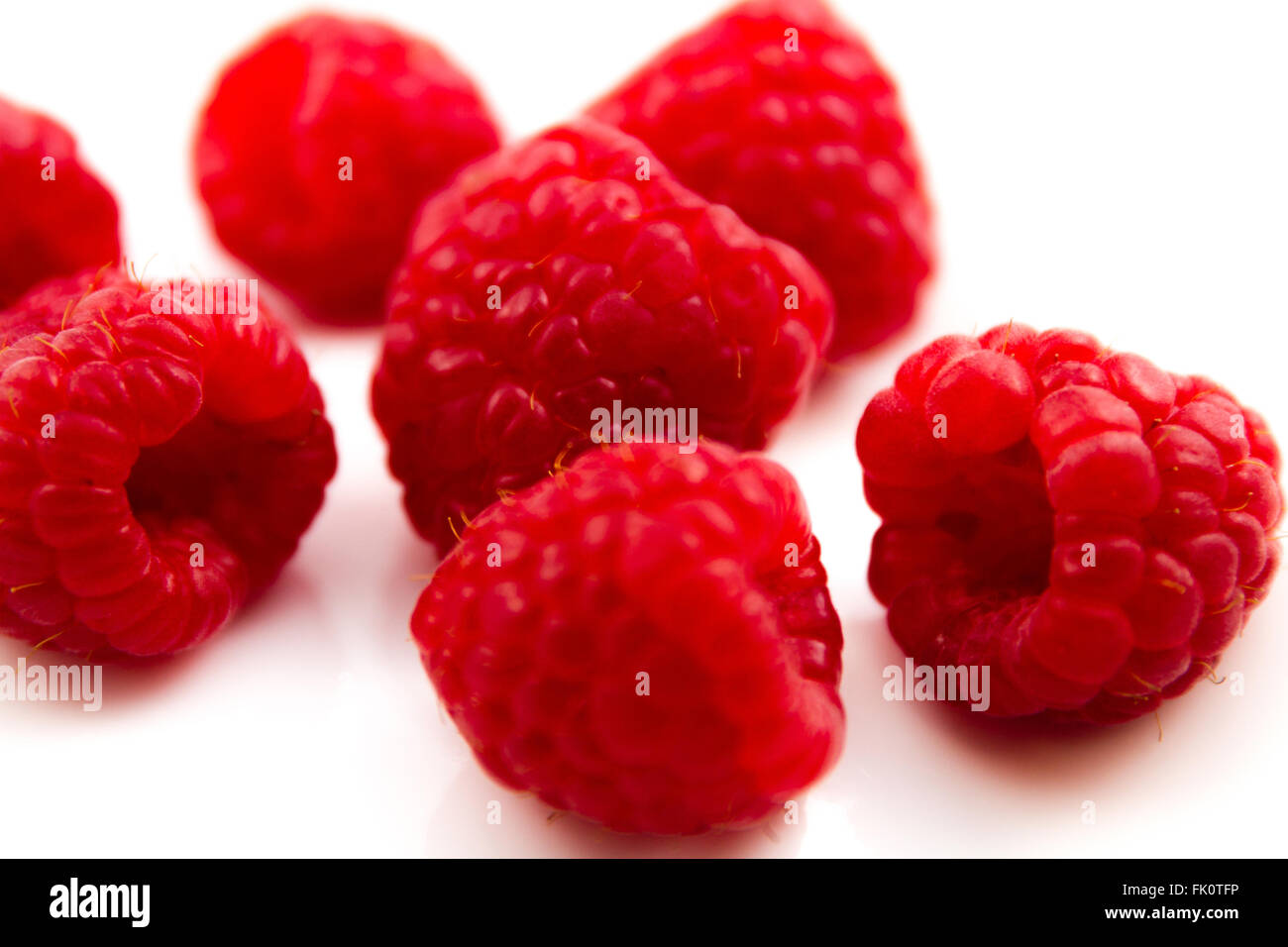 Raspberries on a white background Stock Photo - Alamy