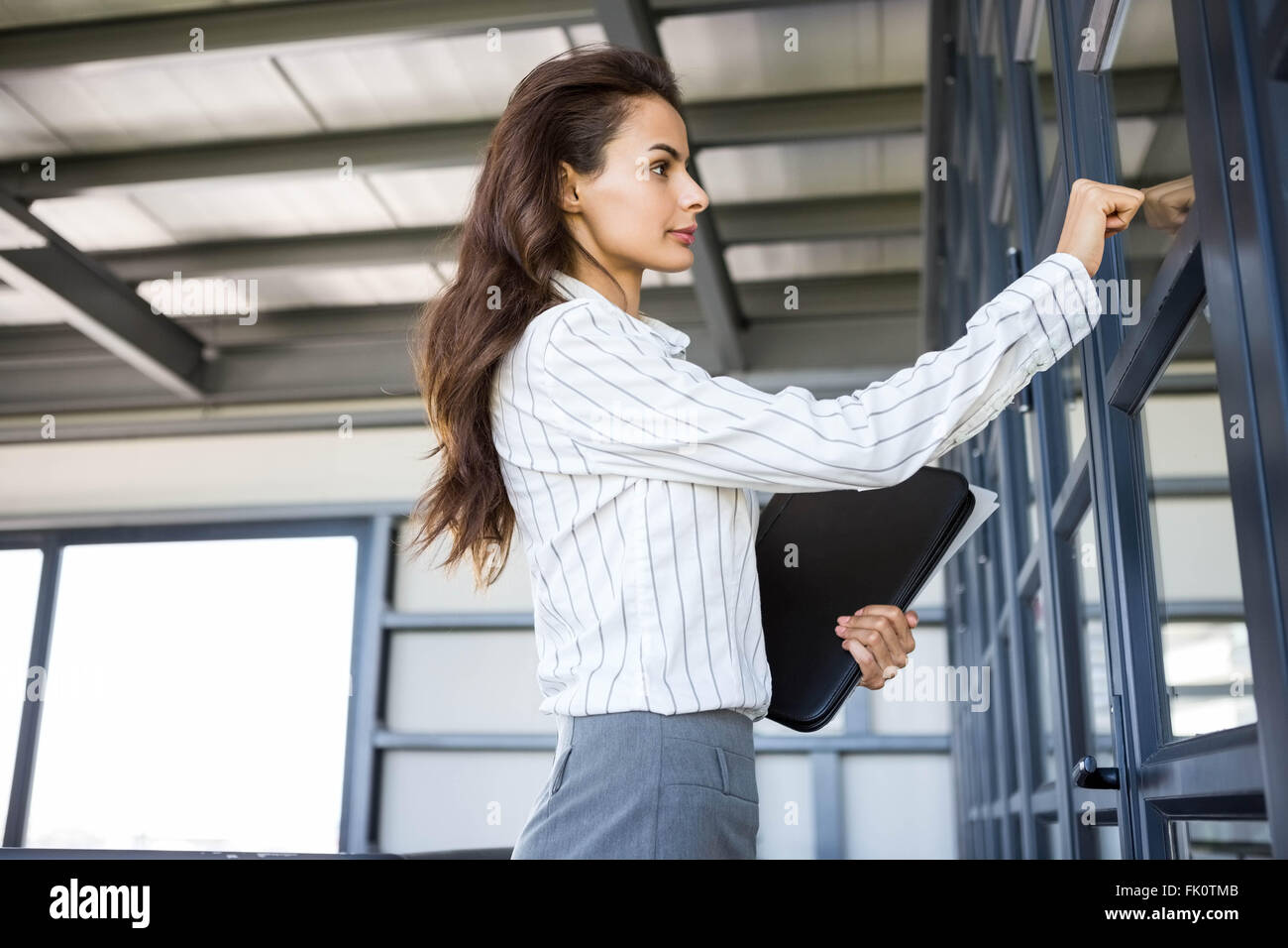 Businesswoman knocking on door Stock Photo - Alamy