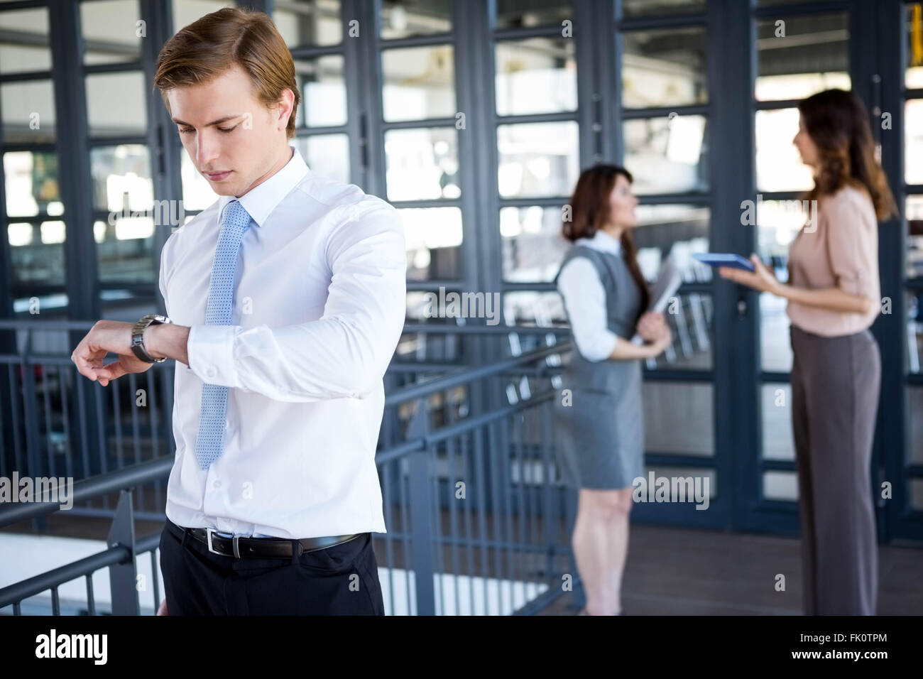 Successful businessman checking time Stock Photo - Alamy