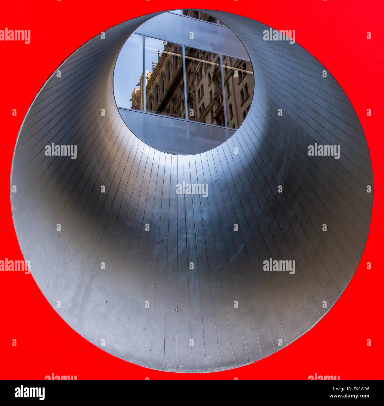 Windows of a building as seen through a hole in a concrete structure ...