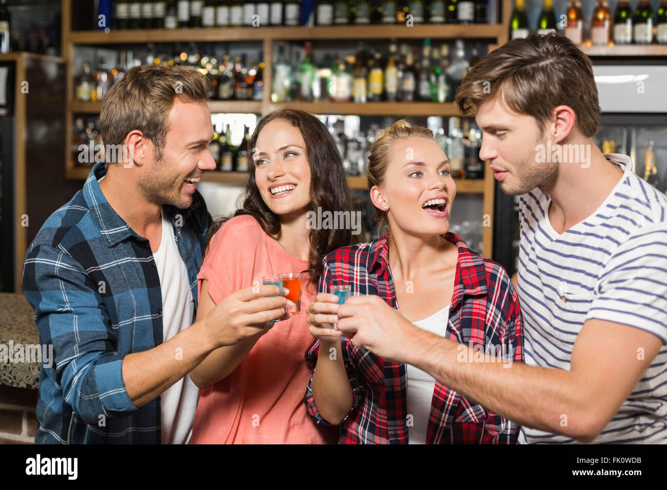 Friends toasting with shots Stock Photo - Alamy