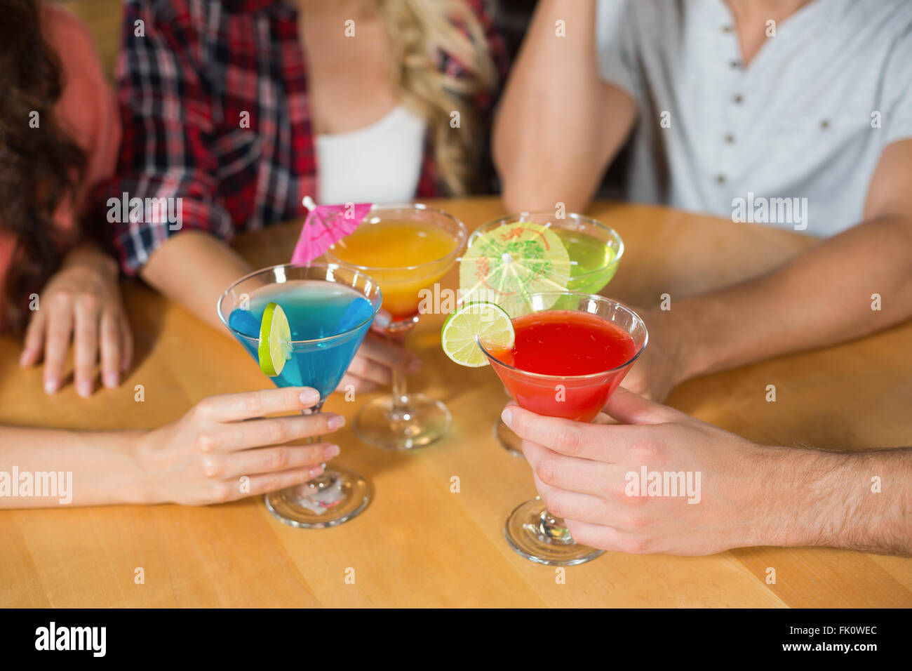 Friends toasting with cocktails Stock Photo - Alamy