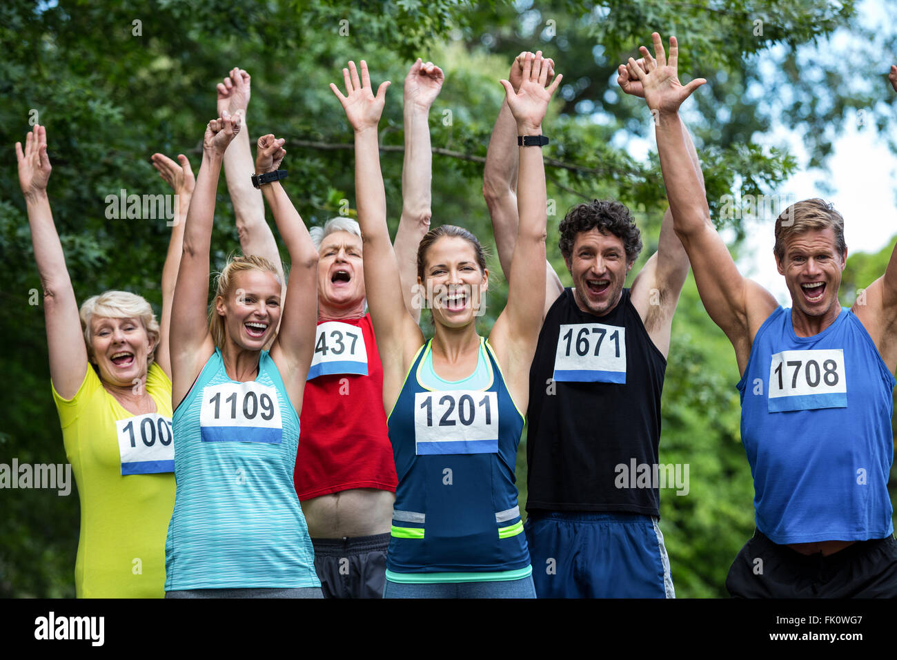Marathon athletes posing with raised arms Stock Photo - Alamy