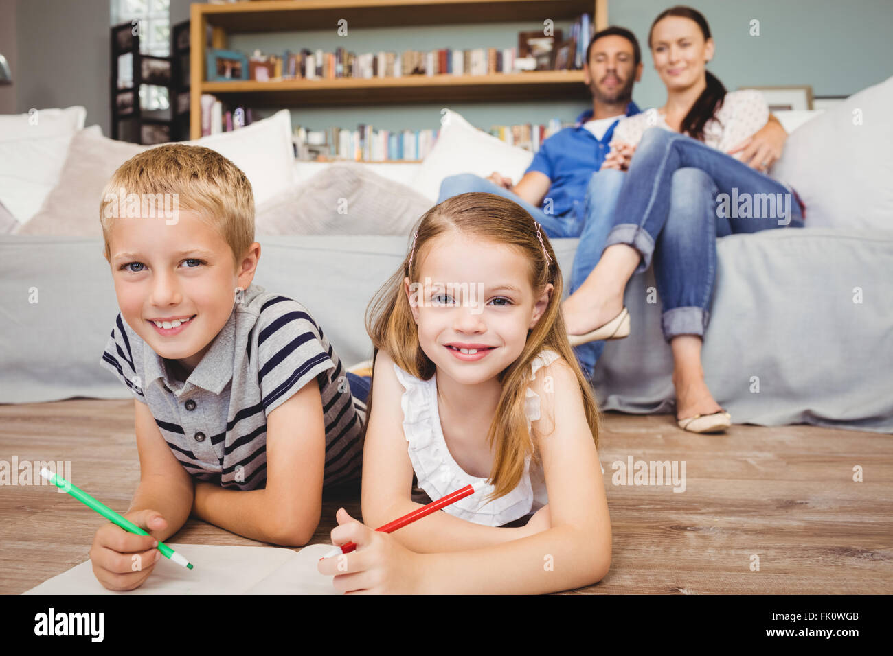 Portrait of happy children coloring on book Stock Photo - Alamy