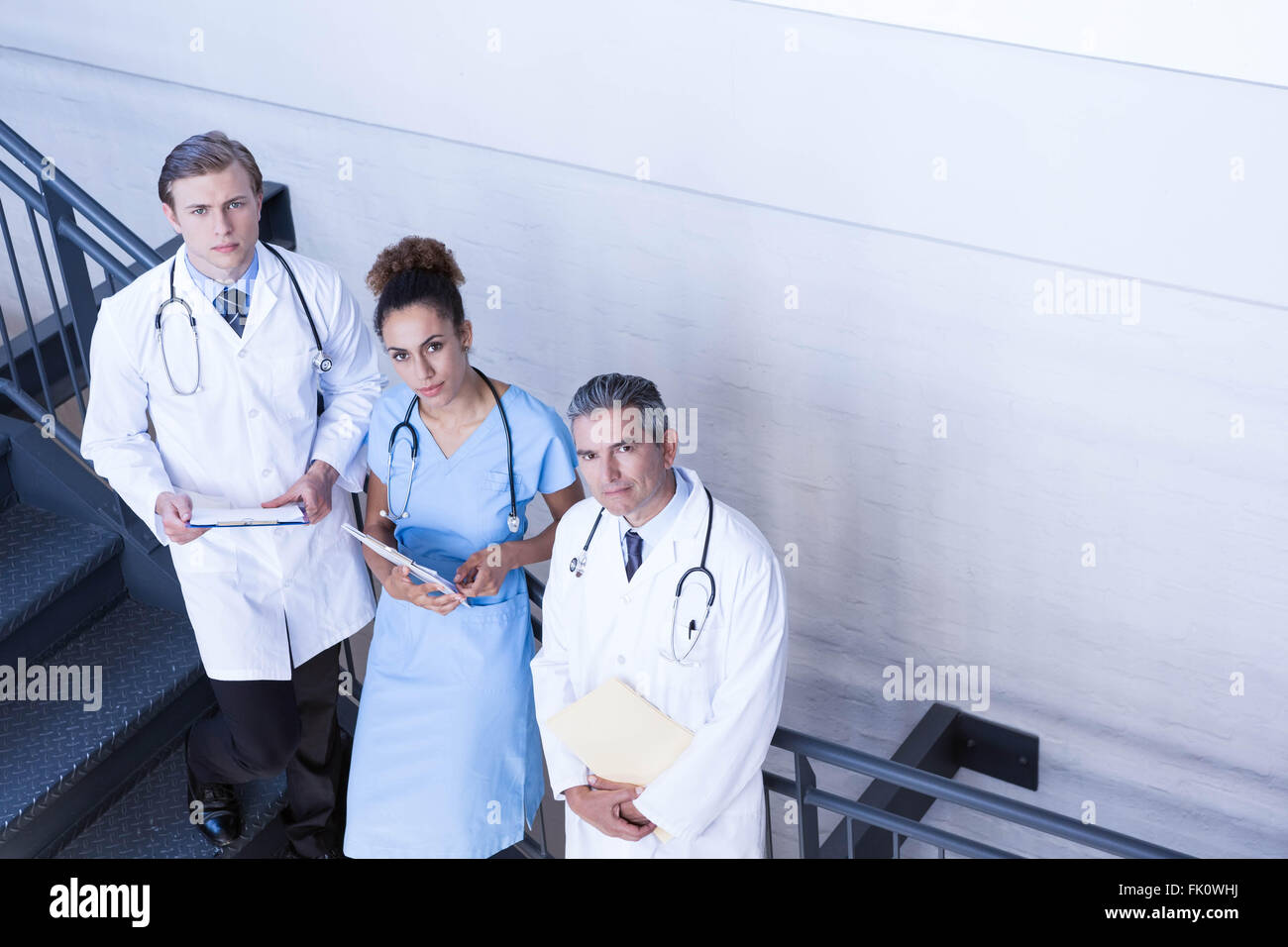 Portrait of doctors standing on staircase with document Stock Photo - Alamy
