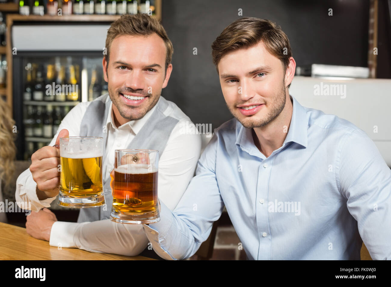 Men toasting with beers Stock Photo - Alamy