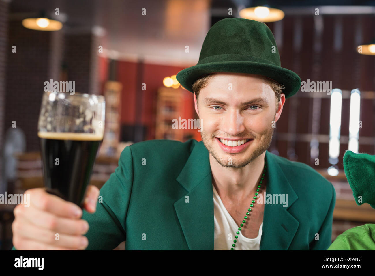 Man with a hat toasting a beer Stock Photo - Alamy
