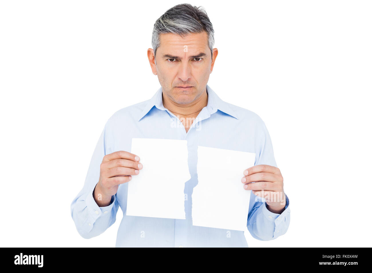 Stern man holding ripped paper Stock Photo - Alamy
