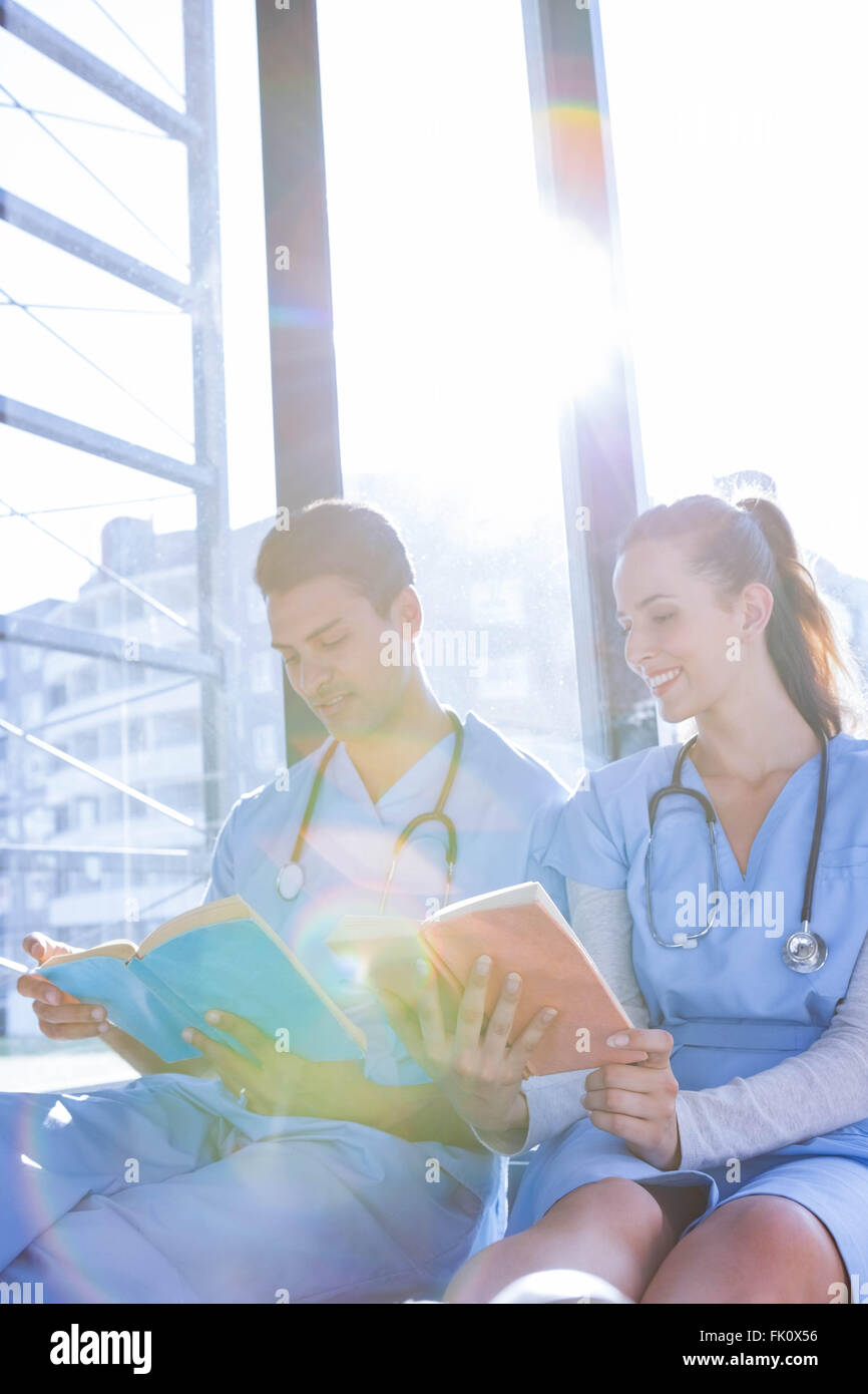Medical team reading book Stock Photo - Alamy