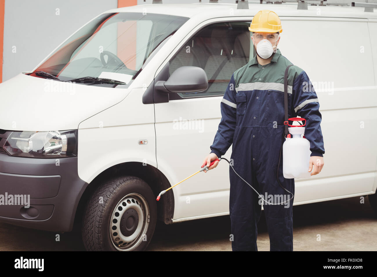 Handyman with insecticide Stock Photo - Alamy