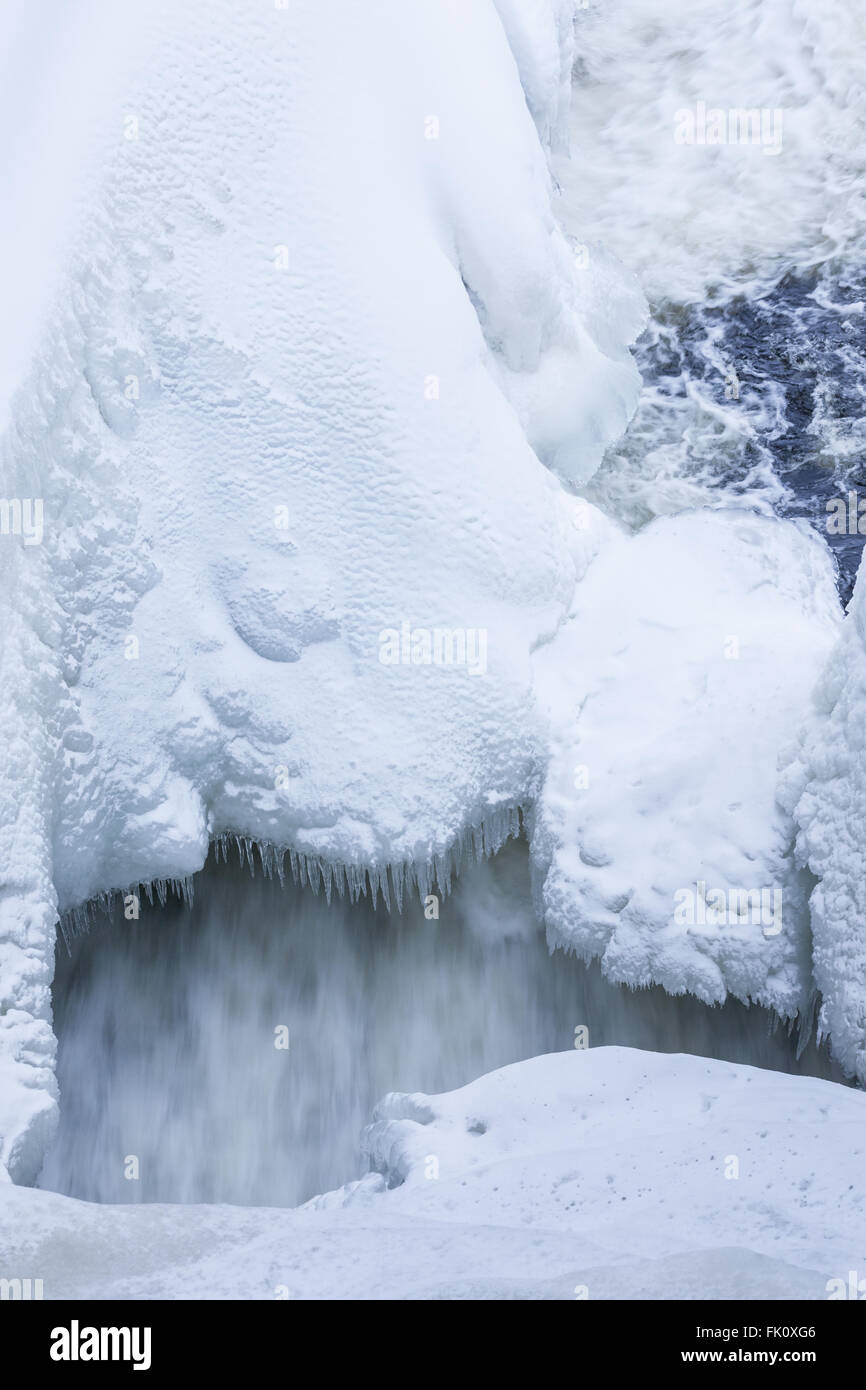 Icicles and snow near flowing water Stock Photo - Alamy
