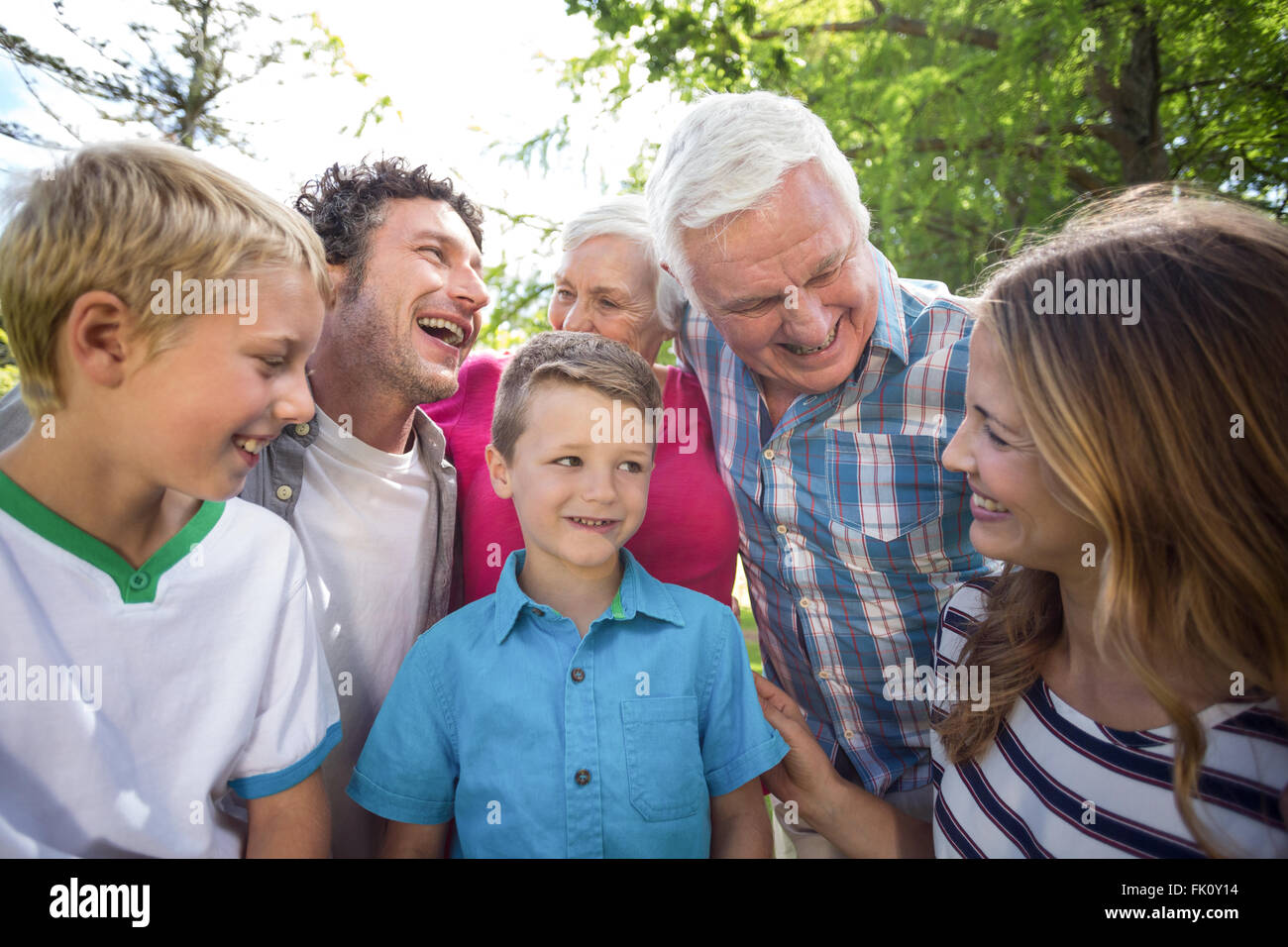 Smiling family standing and laughing Stock Photo - Alamy