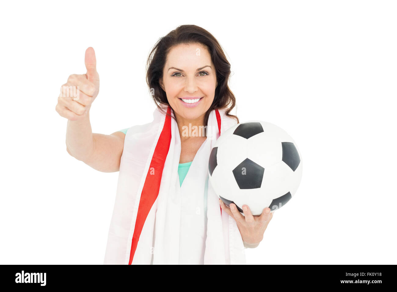 Pretty brunette with thumbs up holding soccer ball Stock Photo - Alamy