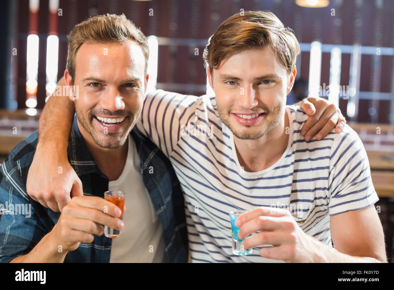 Men toasting with shots Stock Photo - Alamy