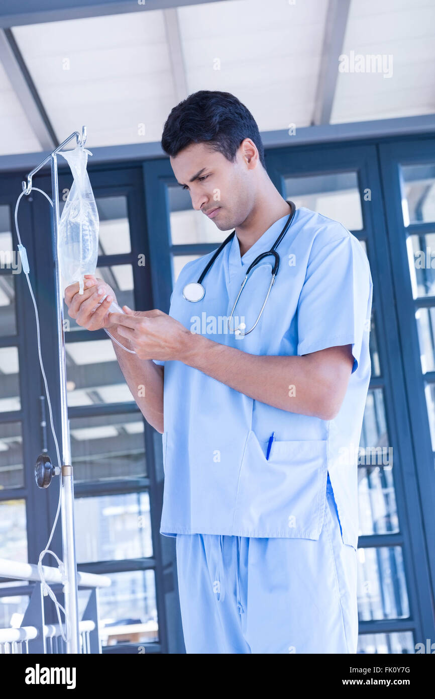 Doctor examining intravenous drip Stock Photo - Alamy