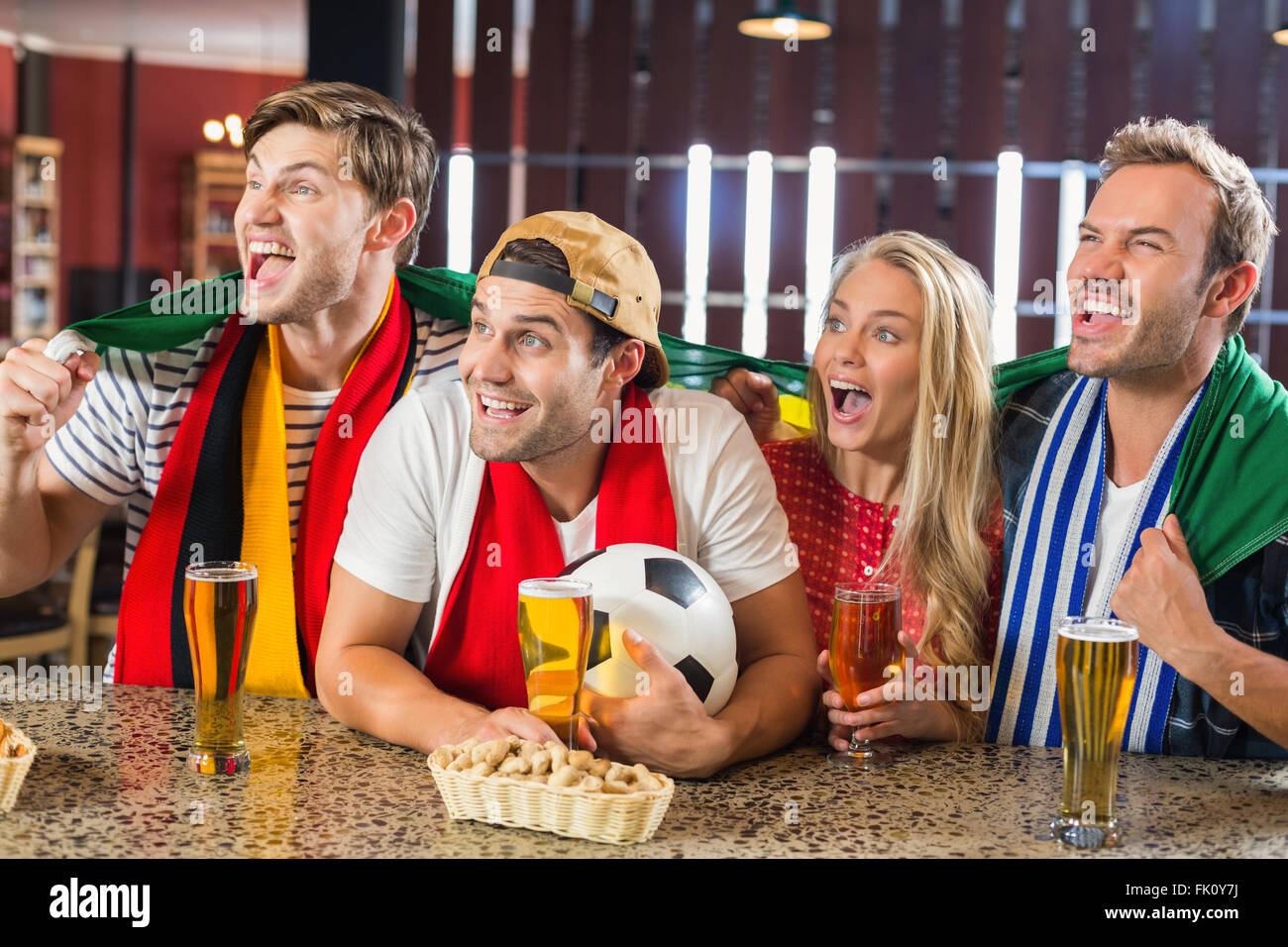 Friends watching tv Stock Photo - Alamy