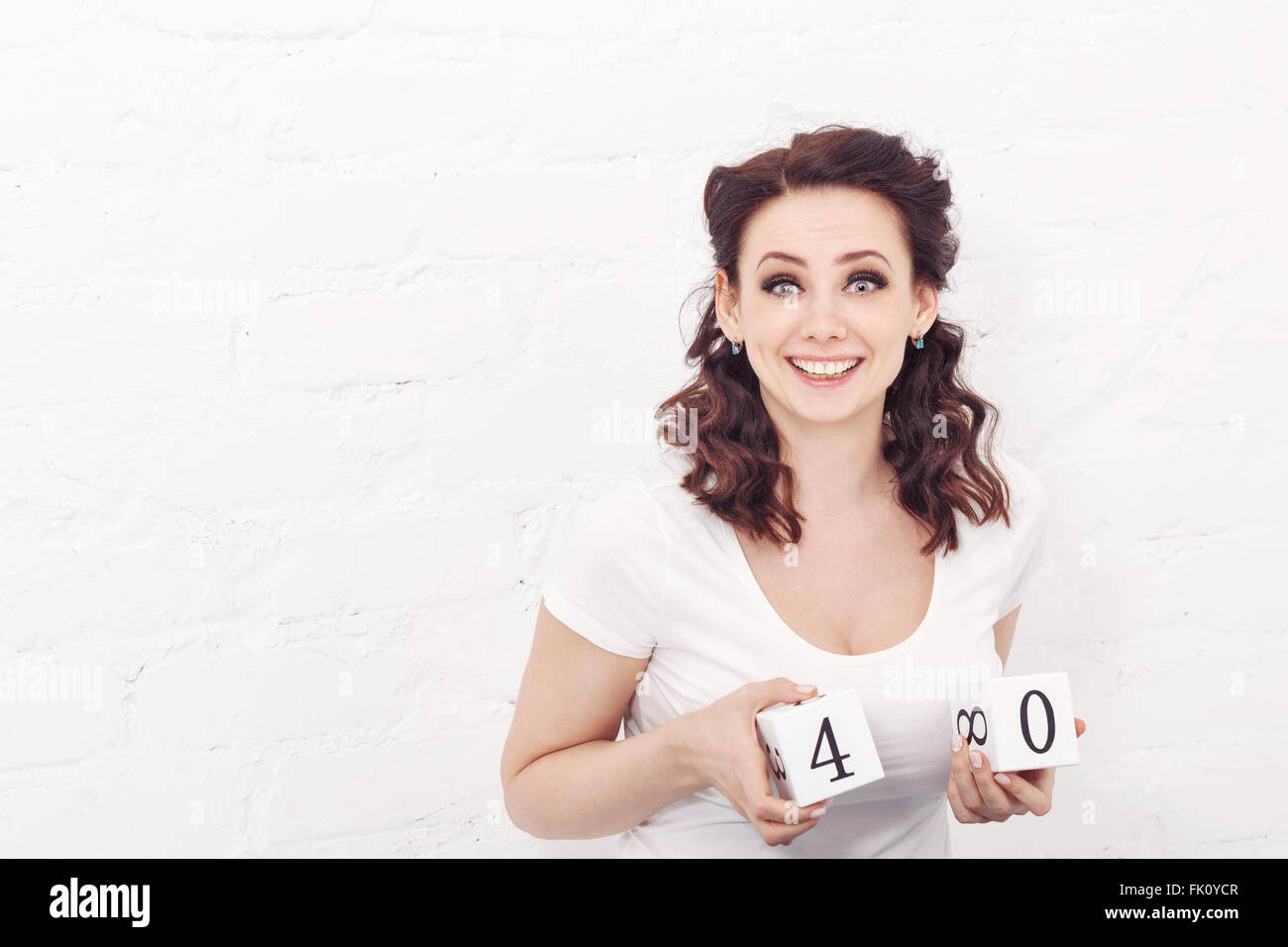 Young cute girl smiling and holding a number forty hands. Girl dressed ...
