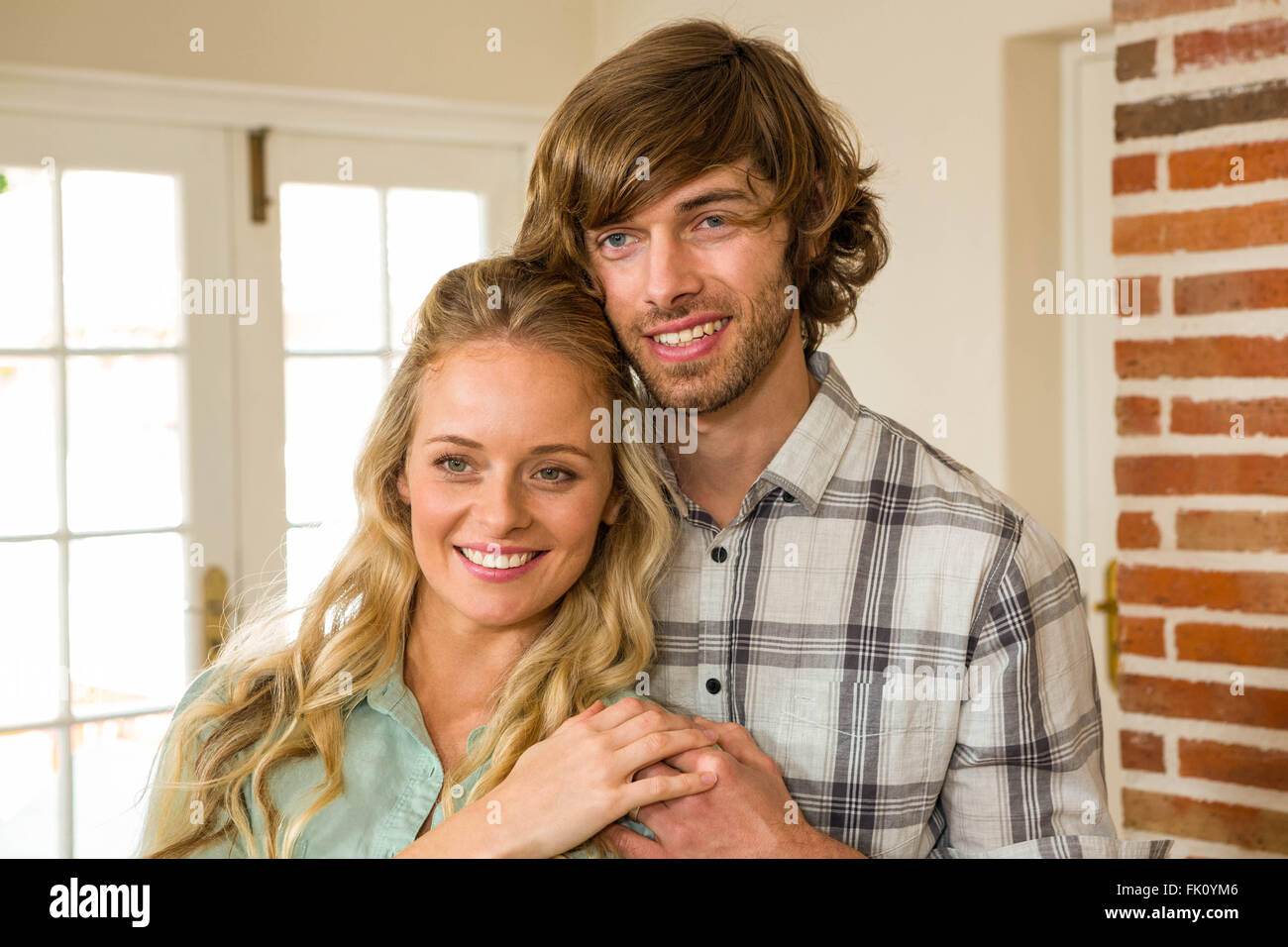Cute couple hugging with arms around Stock Photo - Alamy