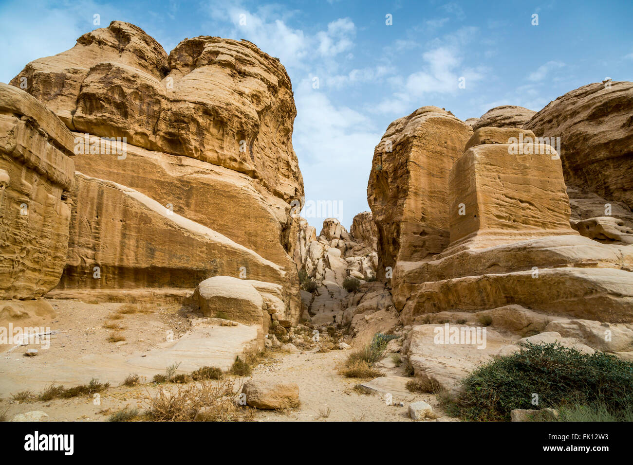 Carved tombs and caves in the Siq passage to the entrance of Petra ...