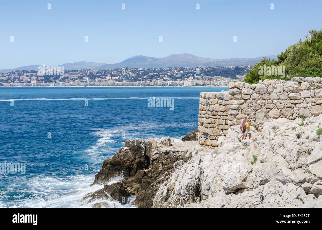 Walkers enjoying a stroll along the coast at Nice, France Stock Photo ...