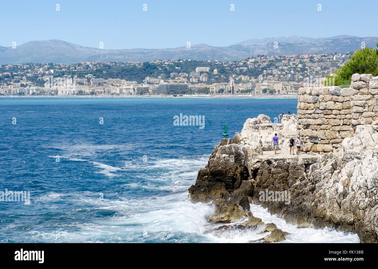 Walkers enjoying a stroll along the coast at Nice, France Stock Photo ...