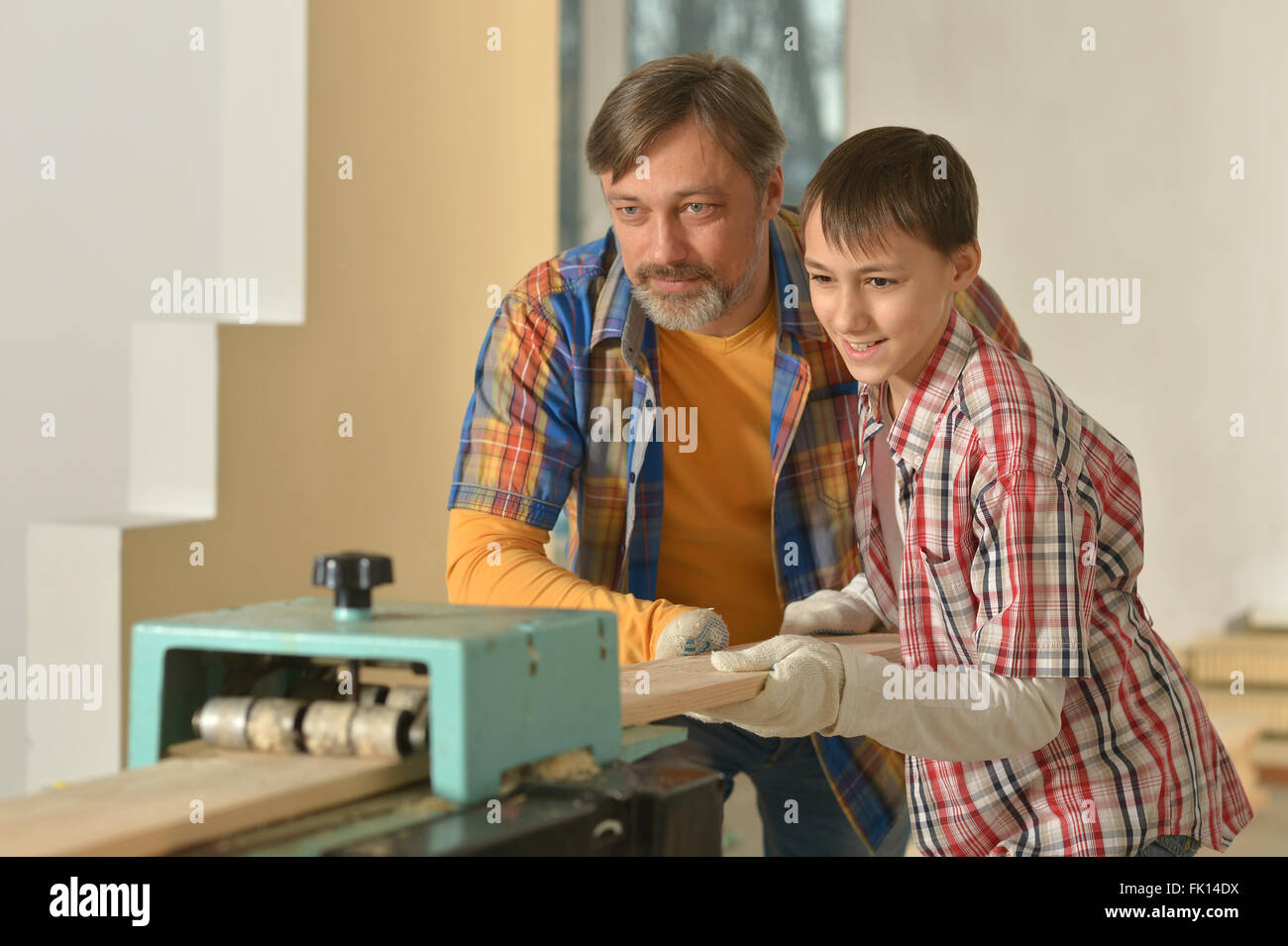 father and little boy repairing in the room Stock Photo - Alamy