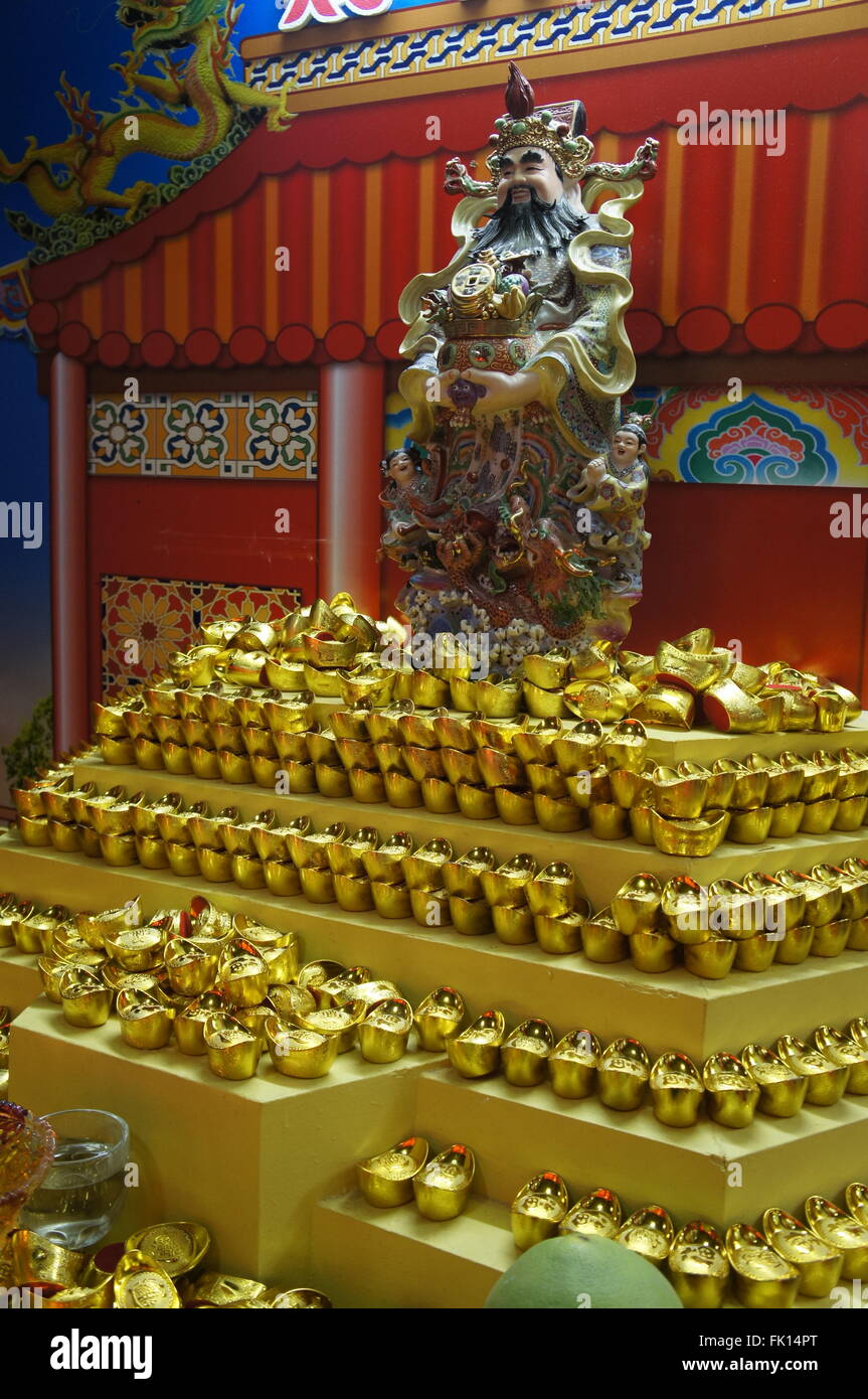 God of Prosperity altar and gold ingots Stock Photo - Alamy